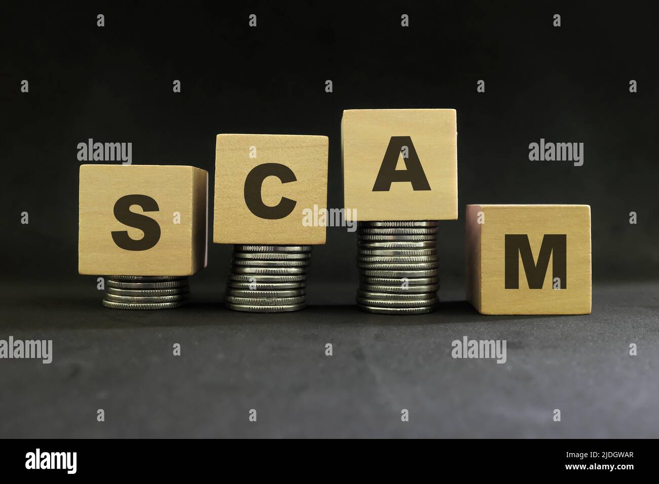 Investment scam, fraud and Ponzi scheme concept. Stack of coins on ...