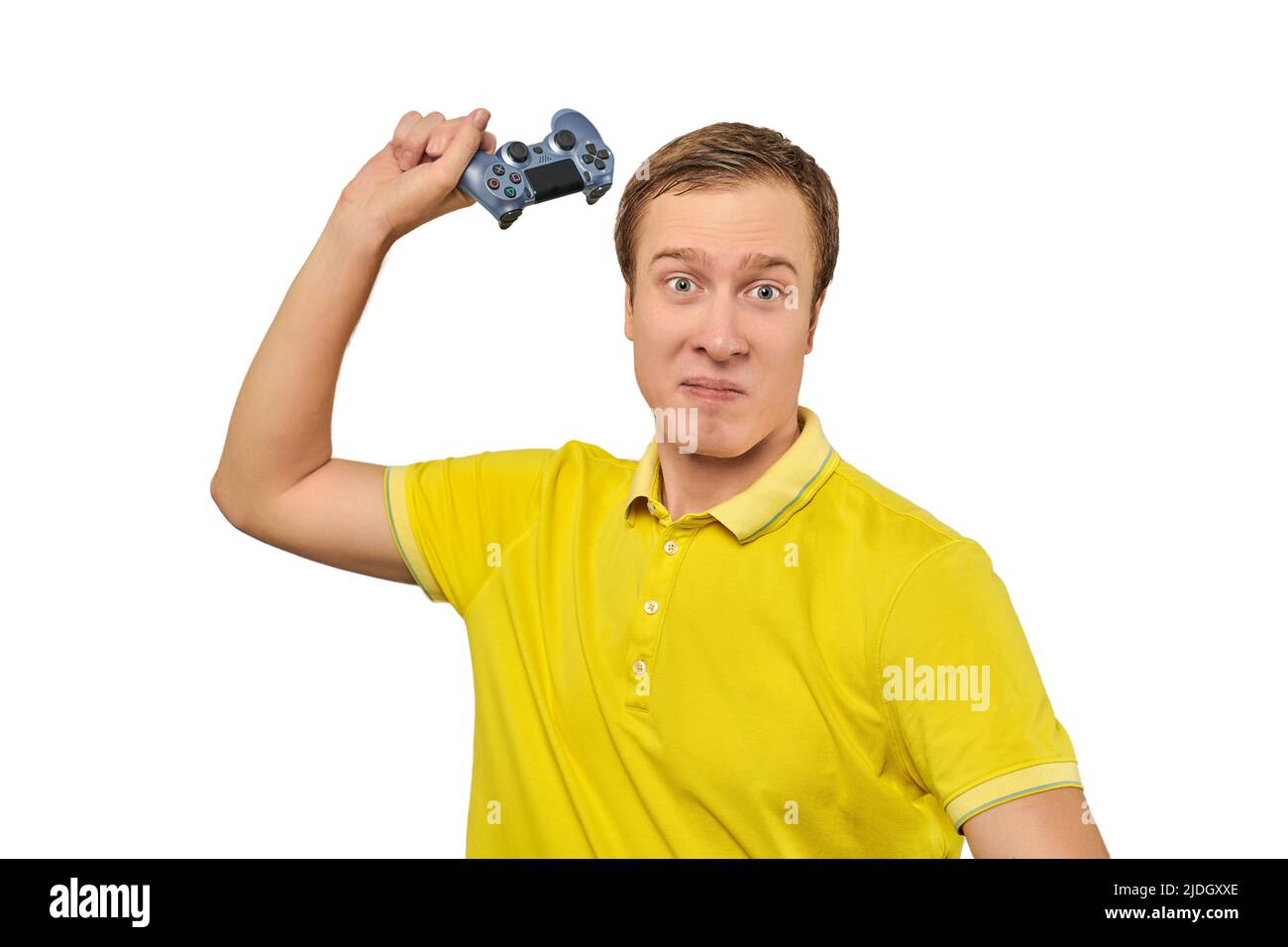 Angry gamer with wireless gamepad dressed in yellow T-shirt isolated on ...