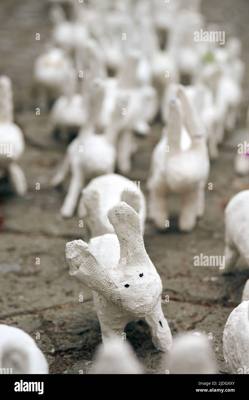 White rabbit statues from plaster close up, outdoor art exhibition ...
