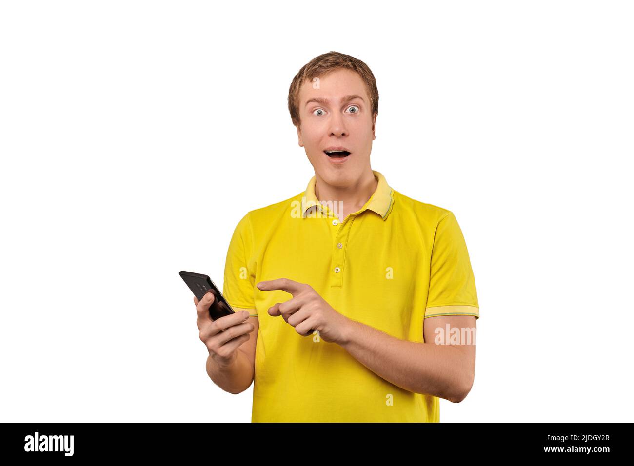 Surprised young man with smartphone isolated on white background. Funny ...