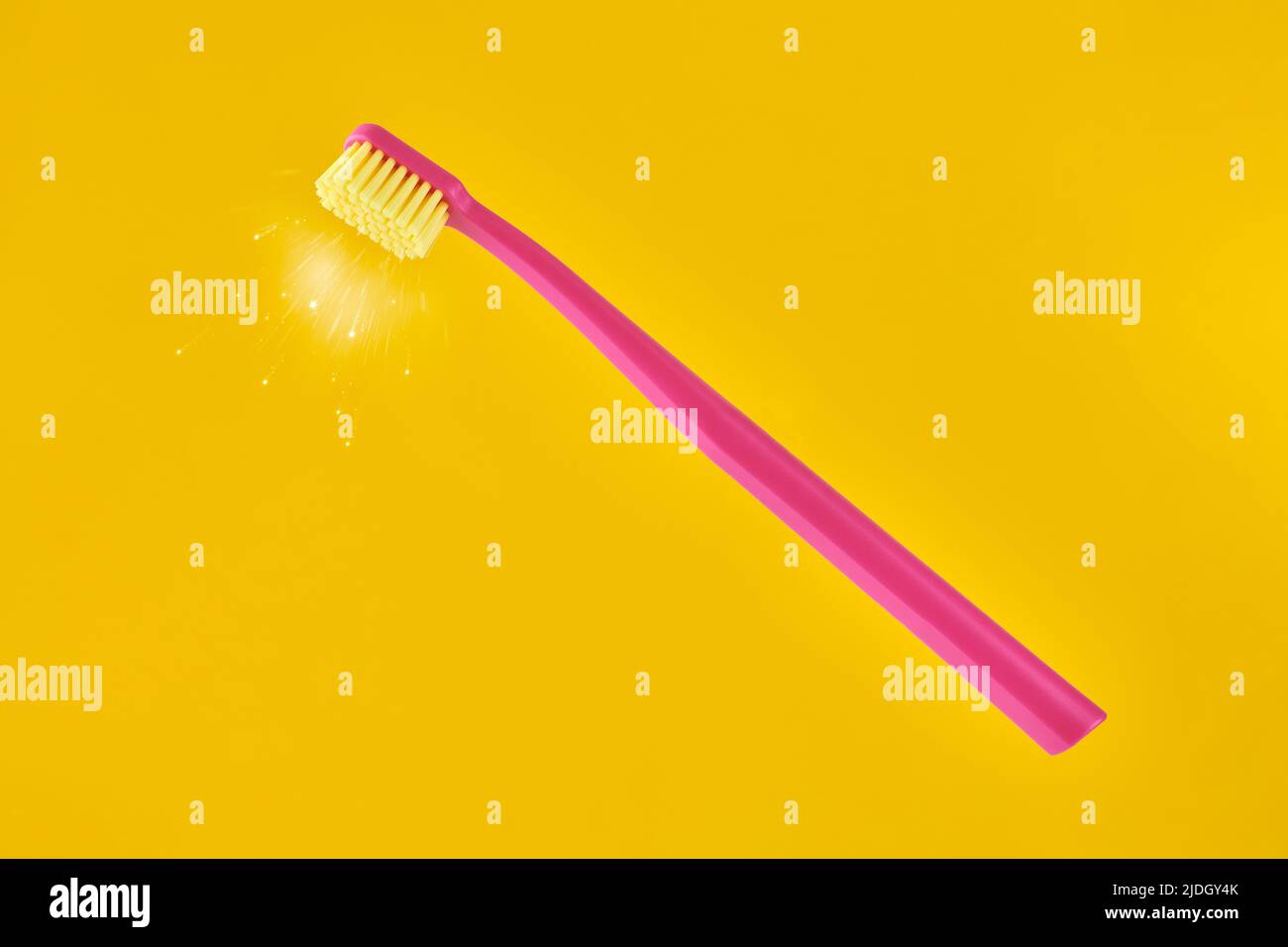 Pink toothbrush on yellow background for oral hygiene to clean teeth ...