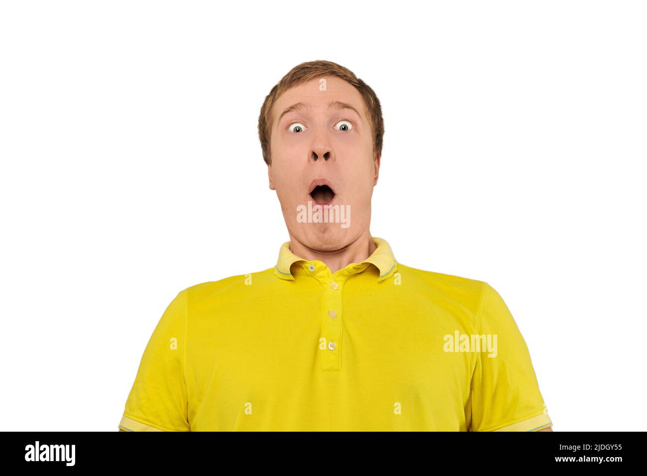 Surprised young guy with funny face in yellow T-shirt, white isolated ...