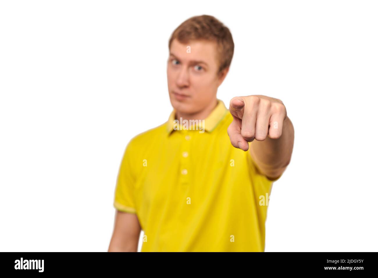 Handsome guy in casual yellow Polo T-shirt pointing finger forward ...