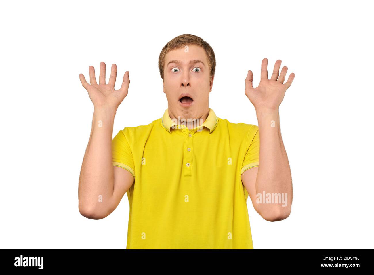 Scared young man in yellow T-shirt with hands up, white isolated ...