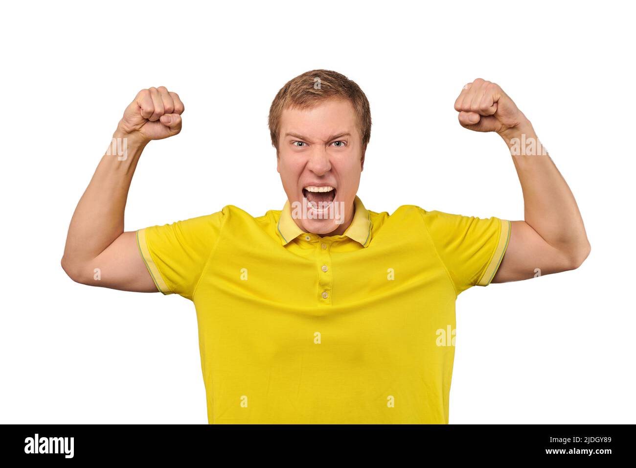 Funny young guy in casual yellow T-shirt raising hands and rejoicing of ...