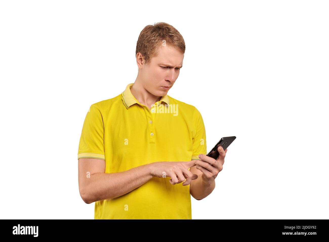 Puzzled young guy with smartphone tapping touchscreen isolated on white ...