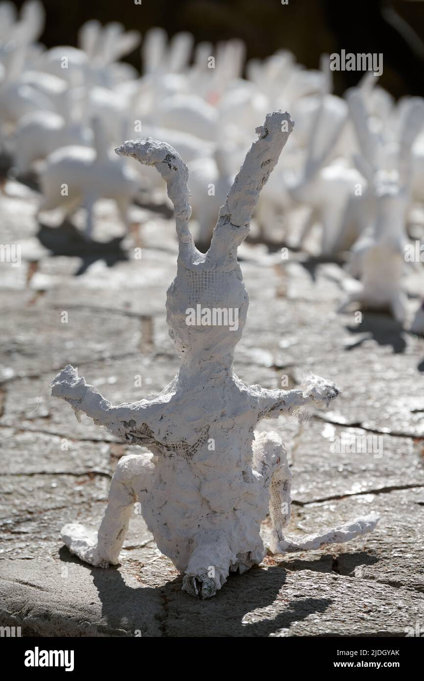 Big white rabbit statue made of plaster back view, outdoor art ...