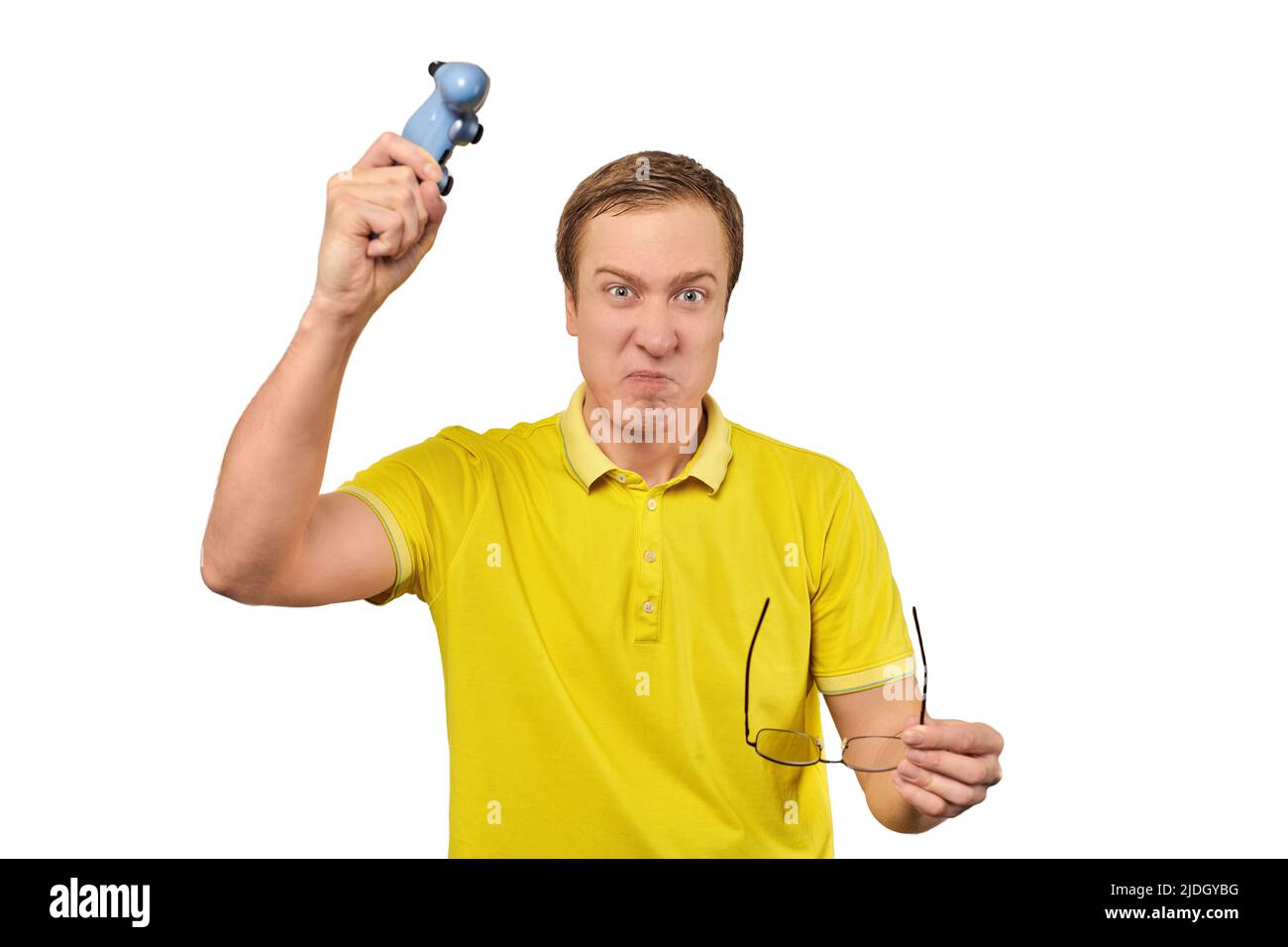 Angry gamer with wireless gamepad dressed in yellow T-shirt isolated on ...
