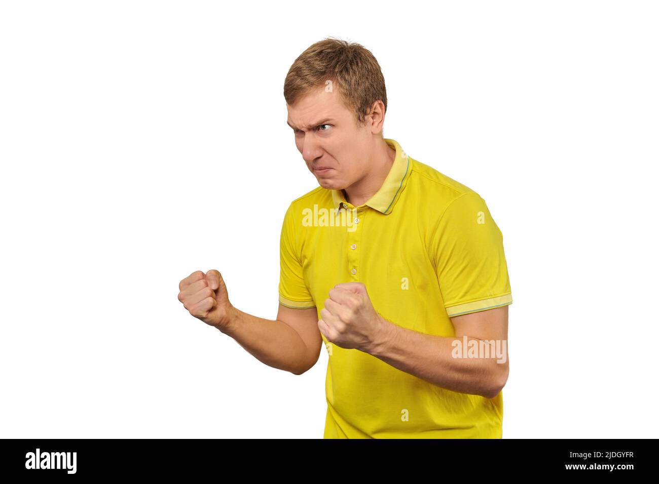 Aggressive angry man in yellow T-shirt looking to left and ready to ...