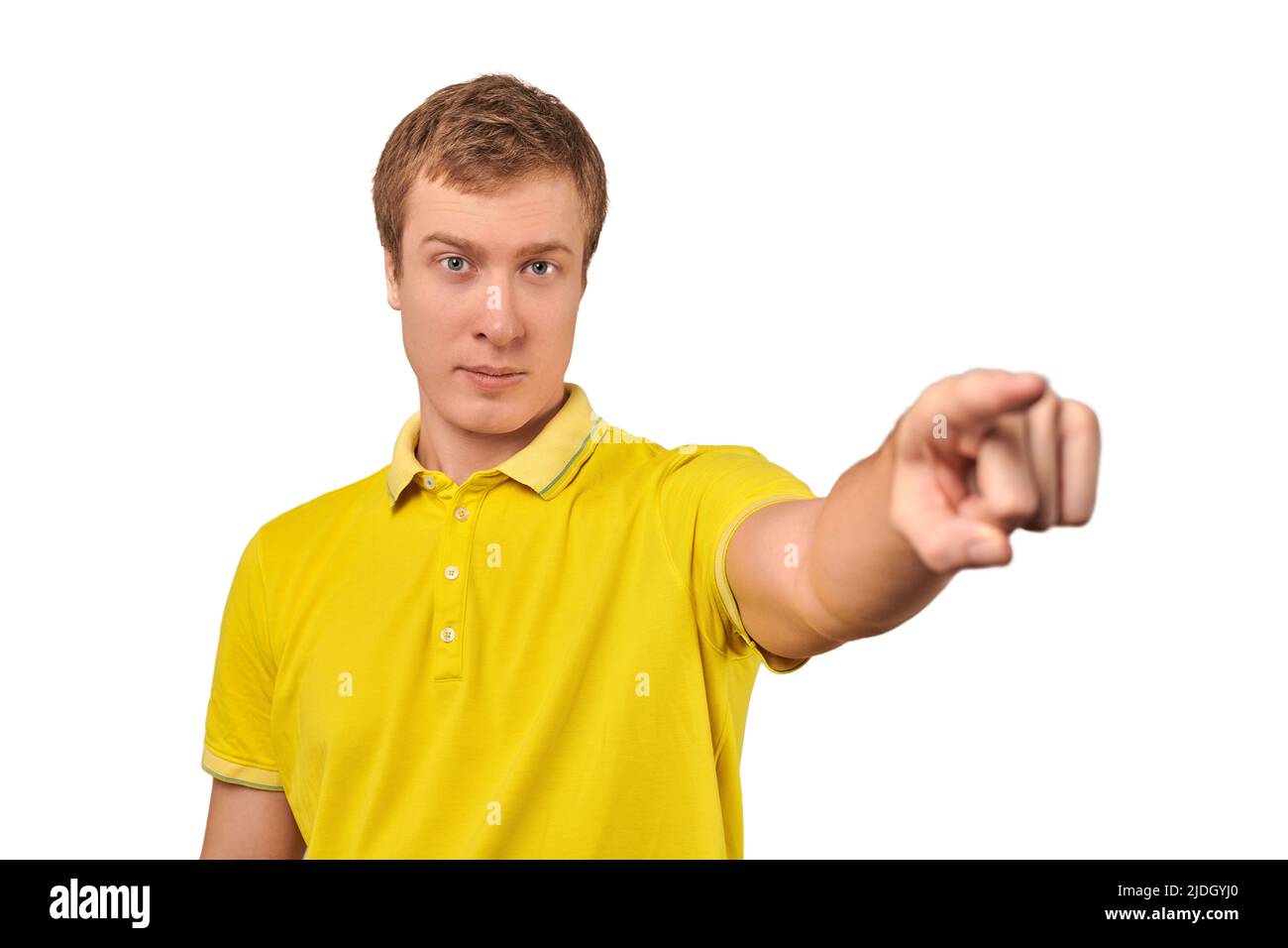 Handsome guy in casual yellow Polo T-shirt pointing finger forward ...