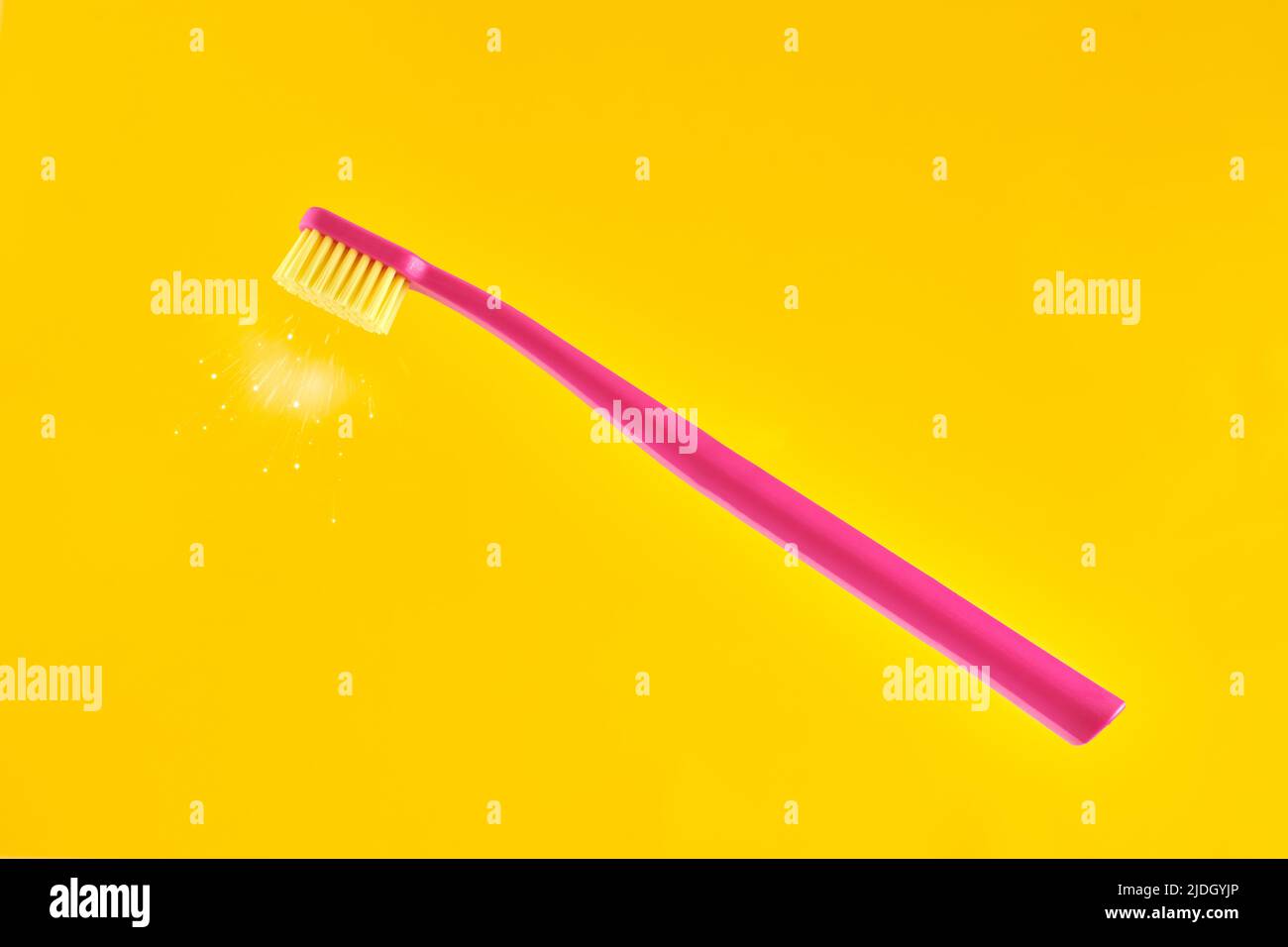 Pink toothbrush on yellow background for oral hygiene to clean teeth ...
