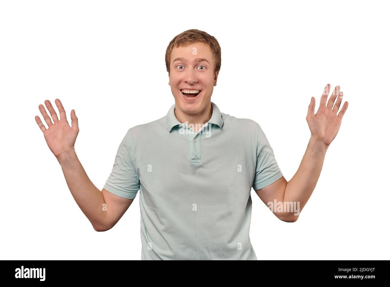Funny smiling guy in mint T-shirt showing palms of hands, unexpected ...