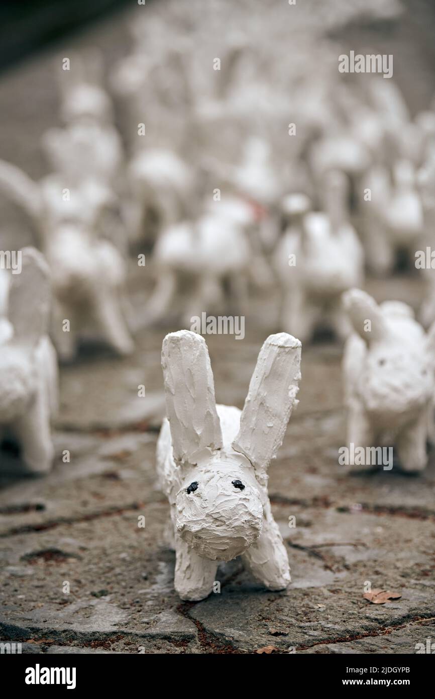 White rabbit statues from plaster close up, outdoor art exhibition ...
