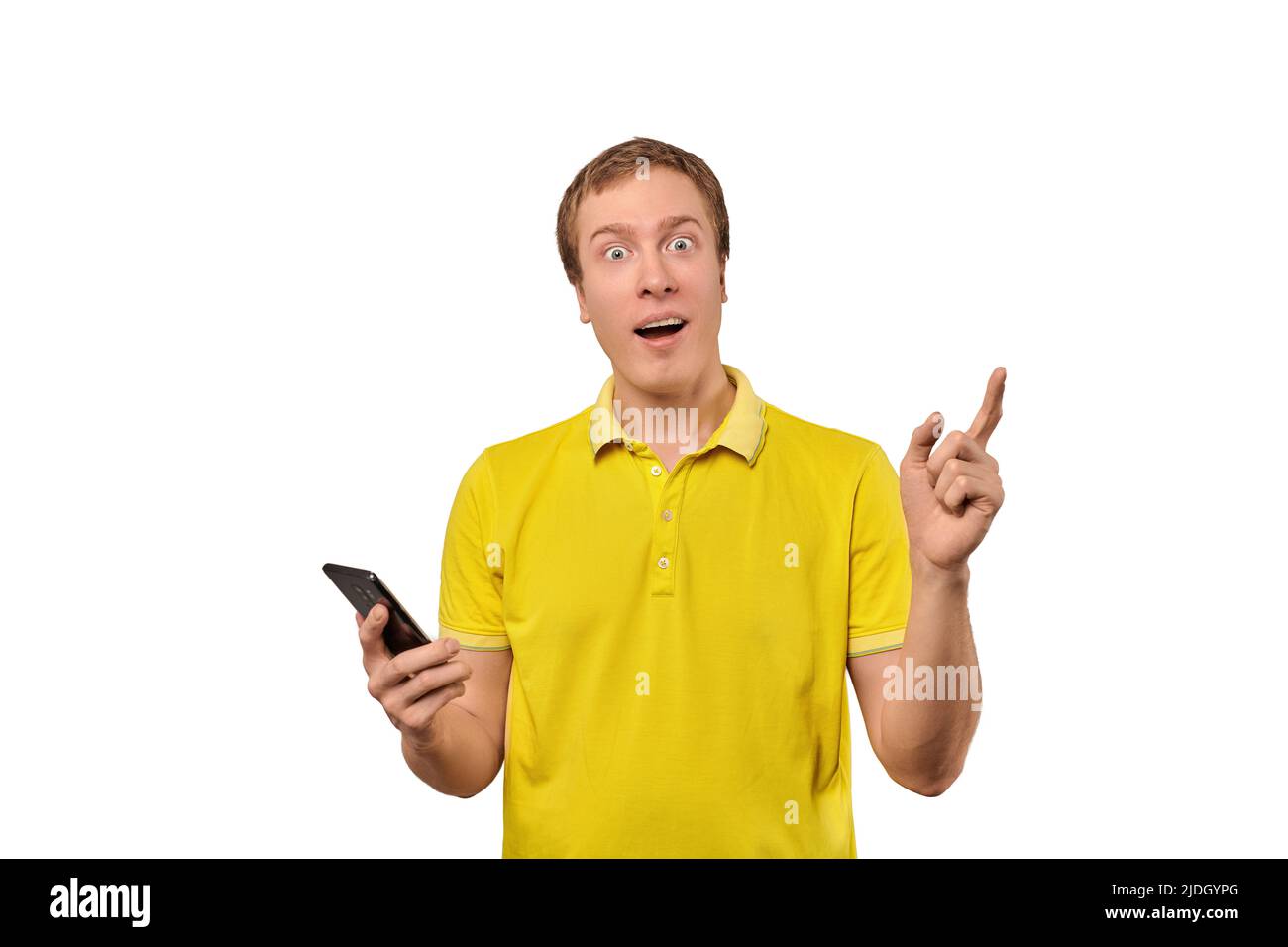Surprised young man with smartphone isolated on white background. Funny ...
