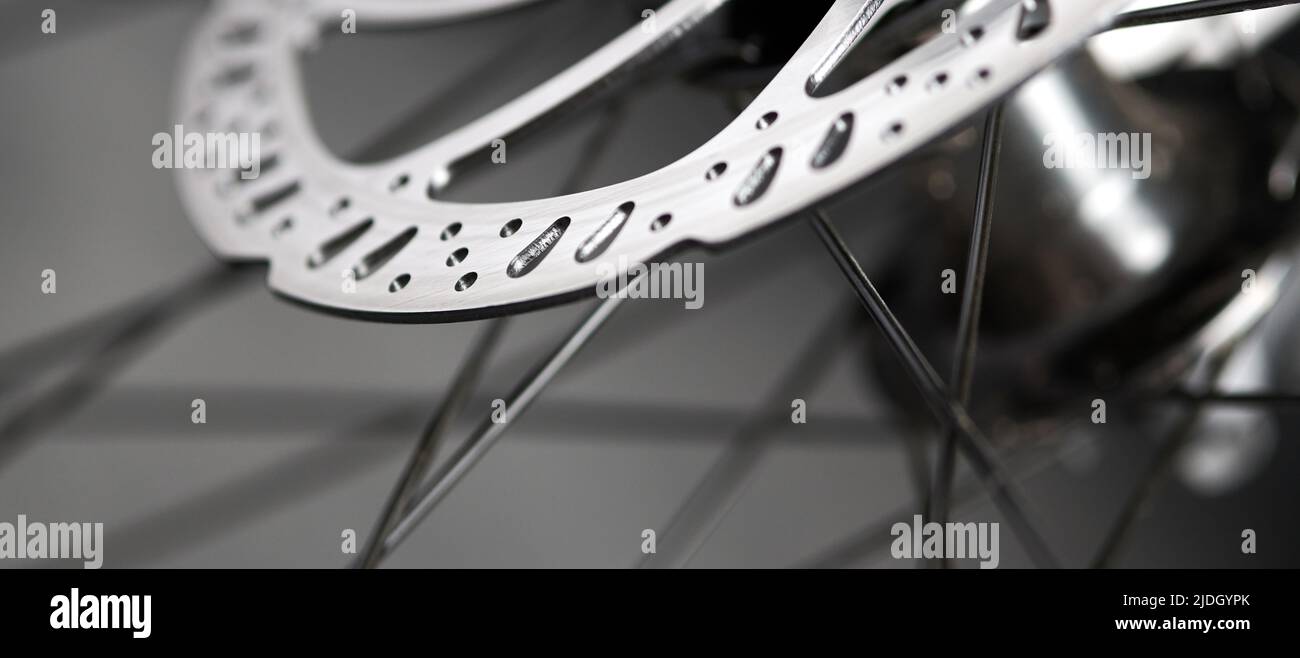 Bicycle disk brakes close up, grey metal disc attached to bike wheel ...