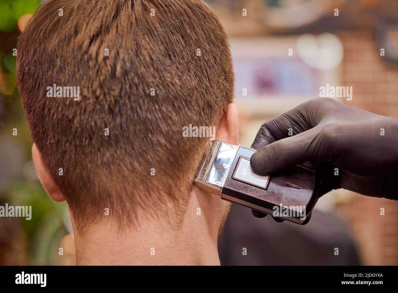 Professional hairdresser makes short hairstyle hi-res stock photography ...