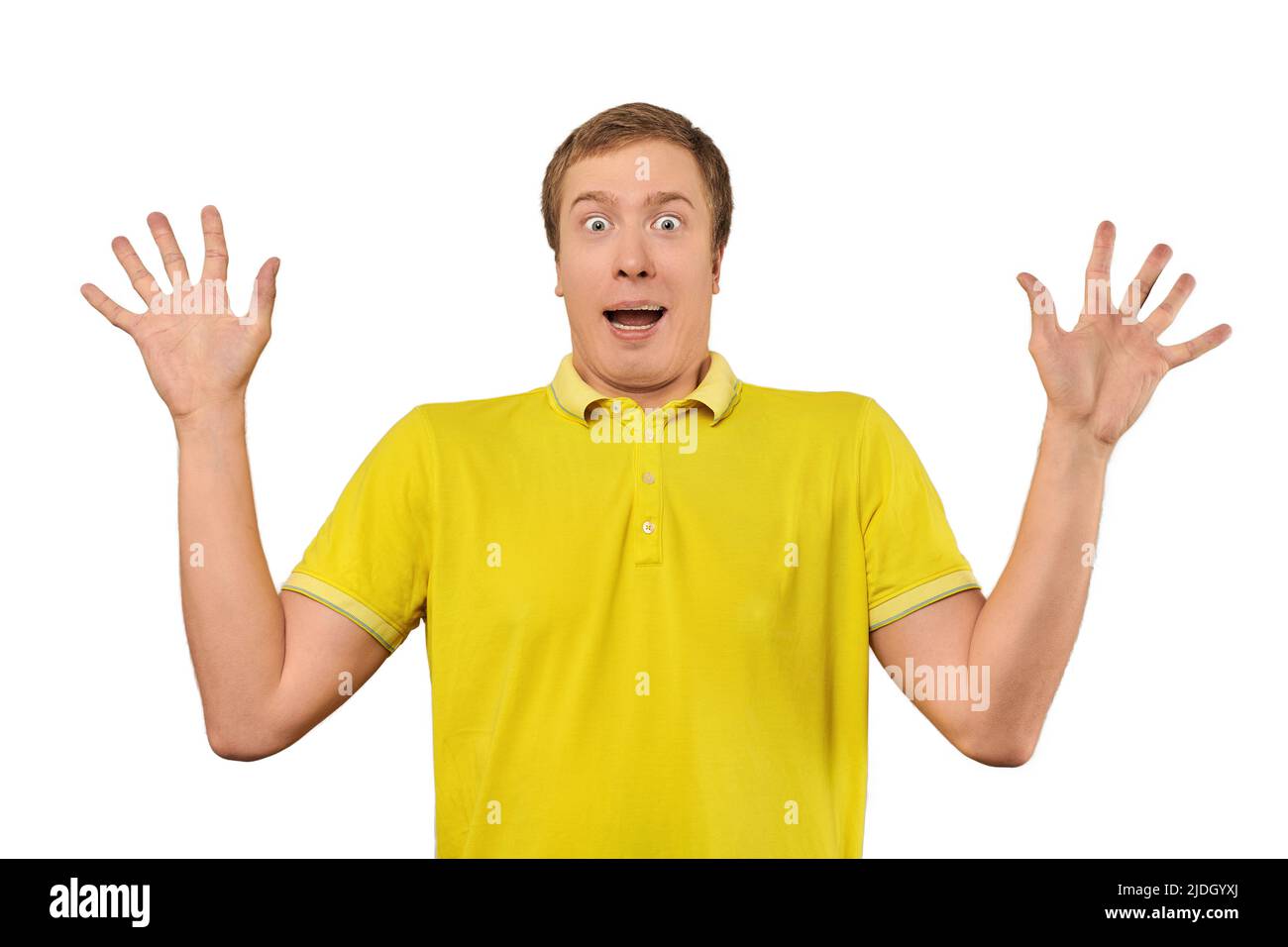 Scared young man in yellow T-shirt with hands up, white isolated ...