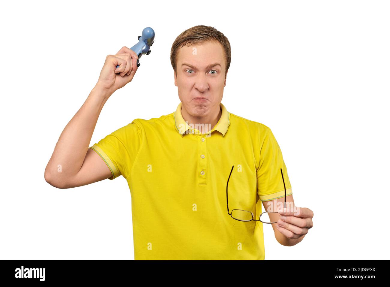 Angry gamer with wireless gamepad dressed in yellow T-shirt isolated on ...