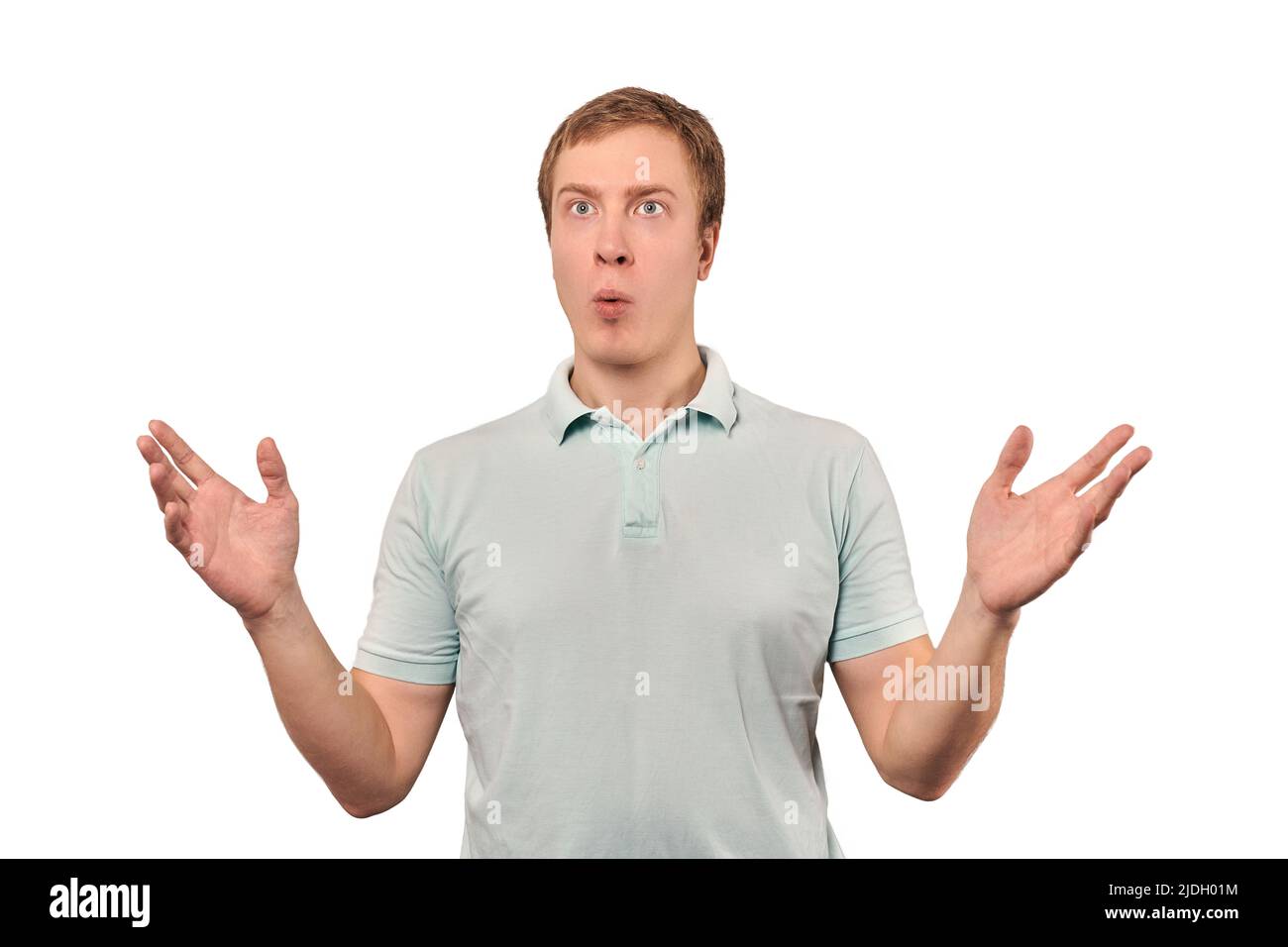 Confused young guy shrugged shoulders, guy in mint casual T-shirt ...