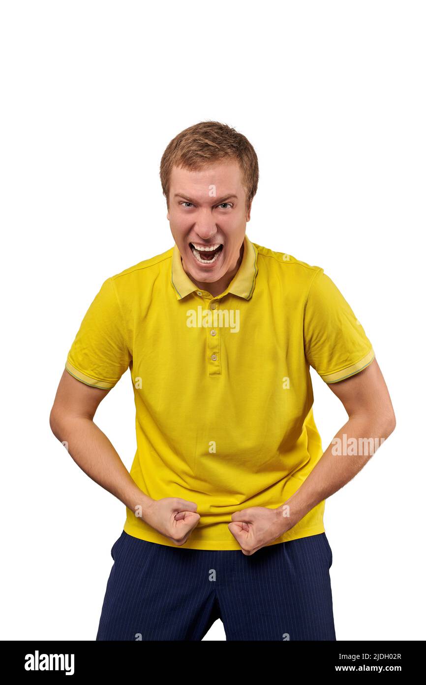 Funny young guy in casual yellow T-shirt showing muscles, successful ...