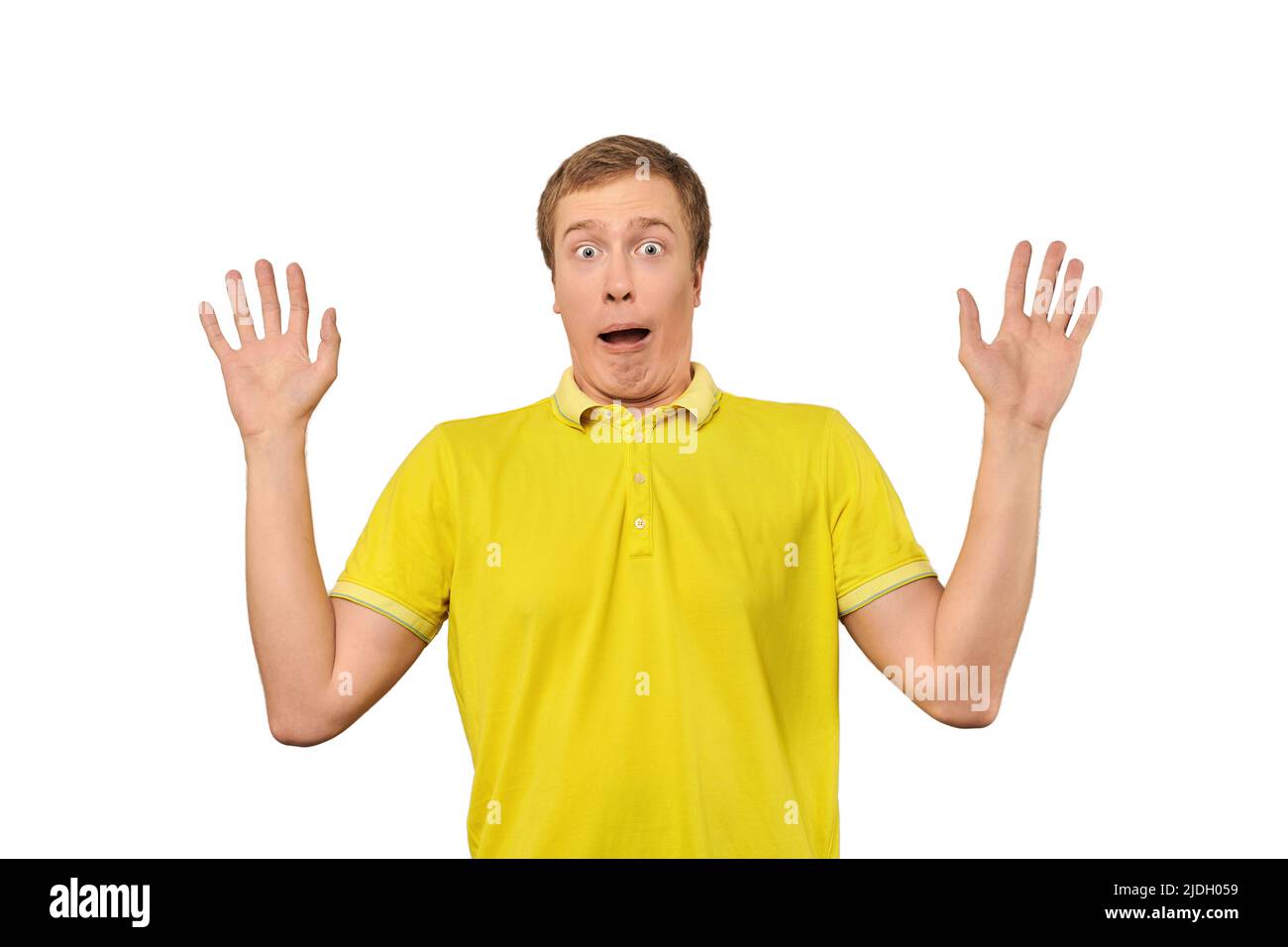 Scared young man in yellow T-shirt with hands up, white isolated ...