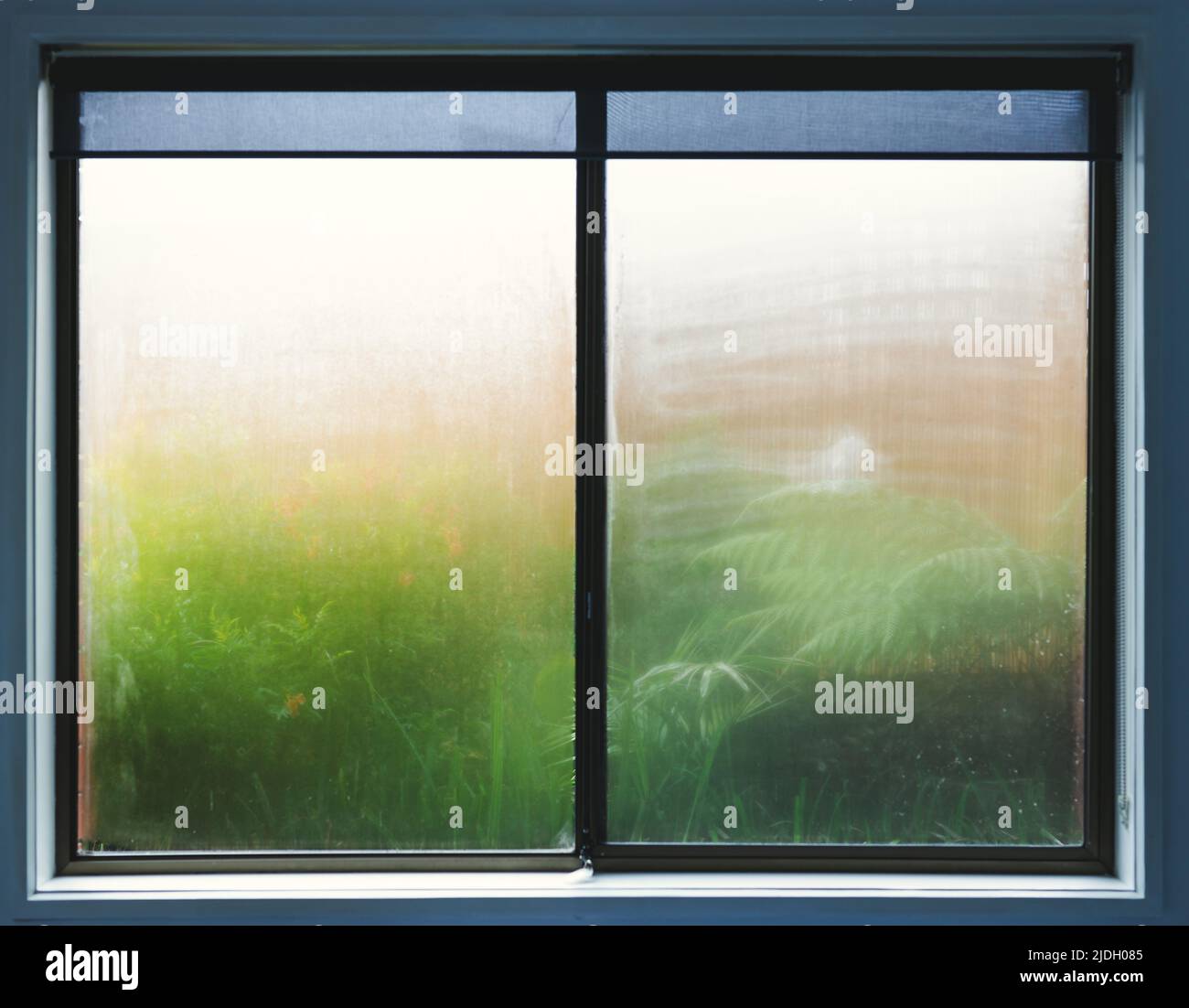 window with water droplets of humidity condensation on window seen from ...