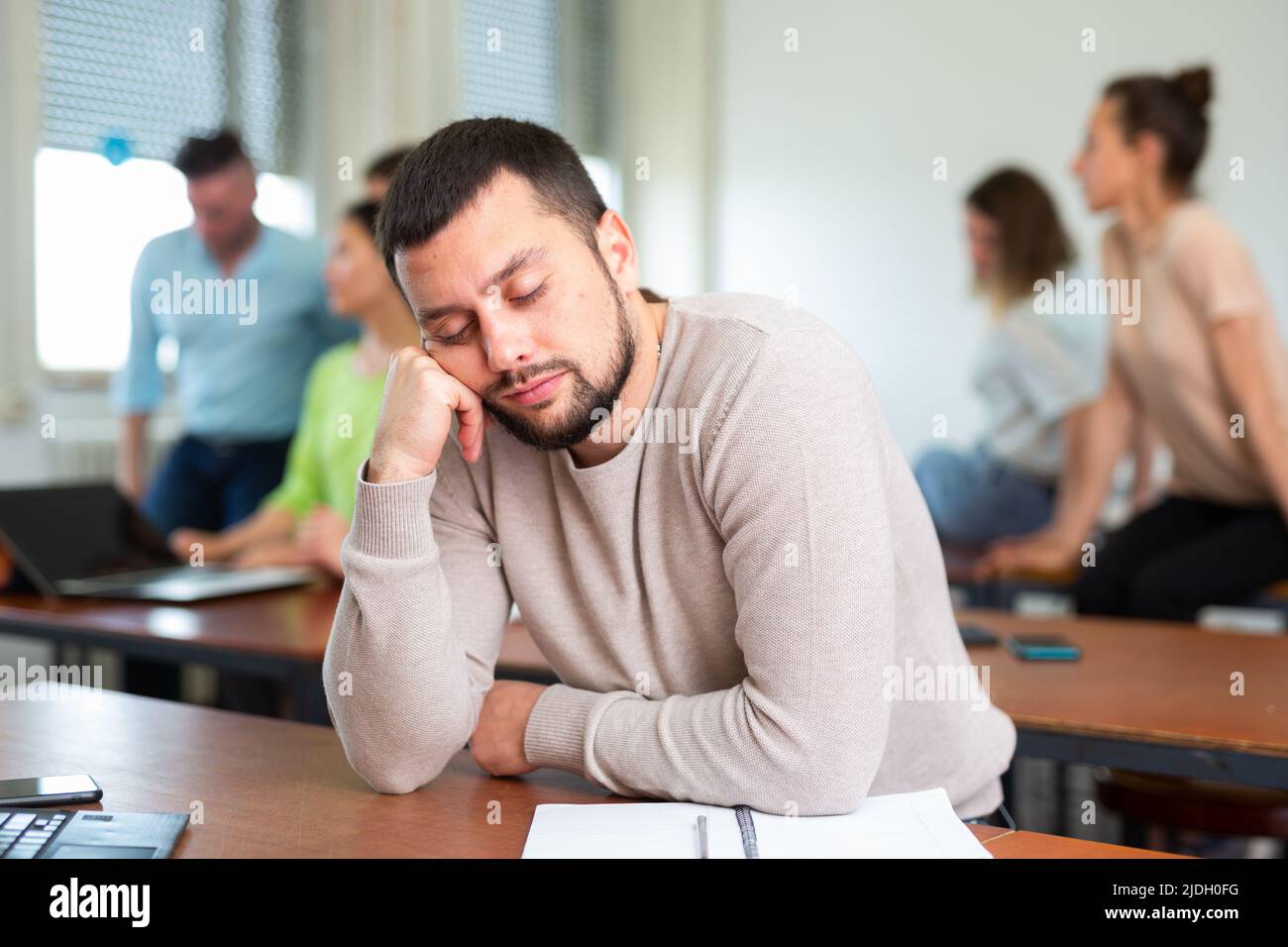 Tired man fell asleep at a lecture in university auditorium Stock Photo ...