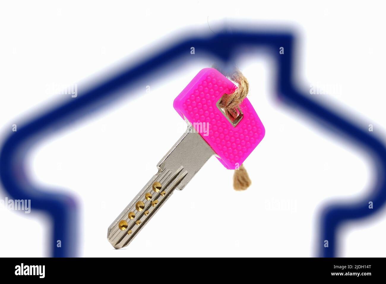 Key to the small house isolated on white background Stock Photo - Alamy