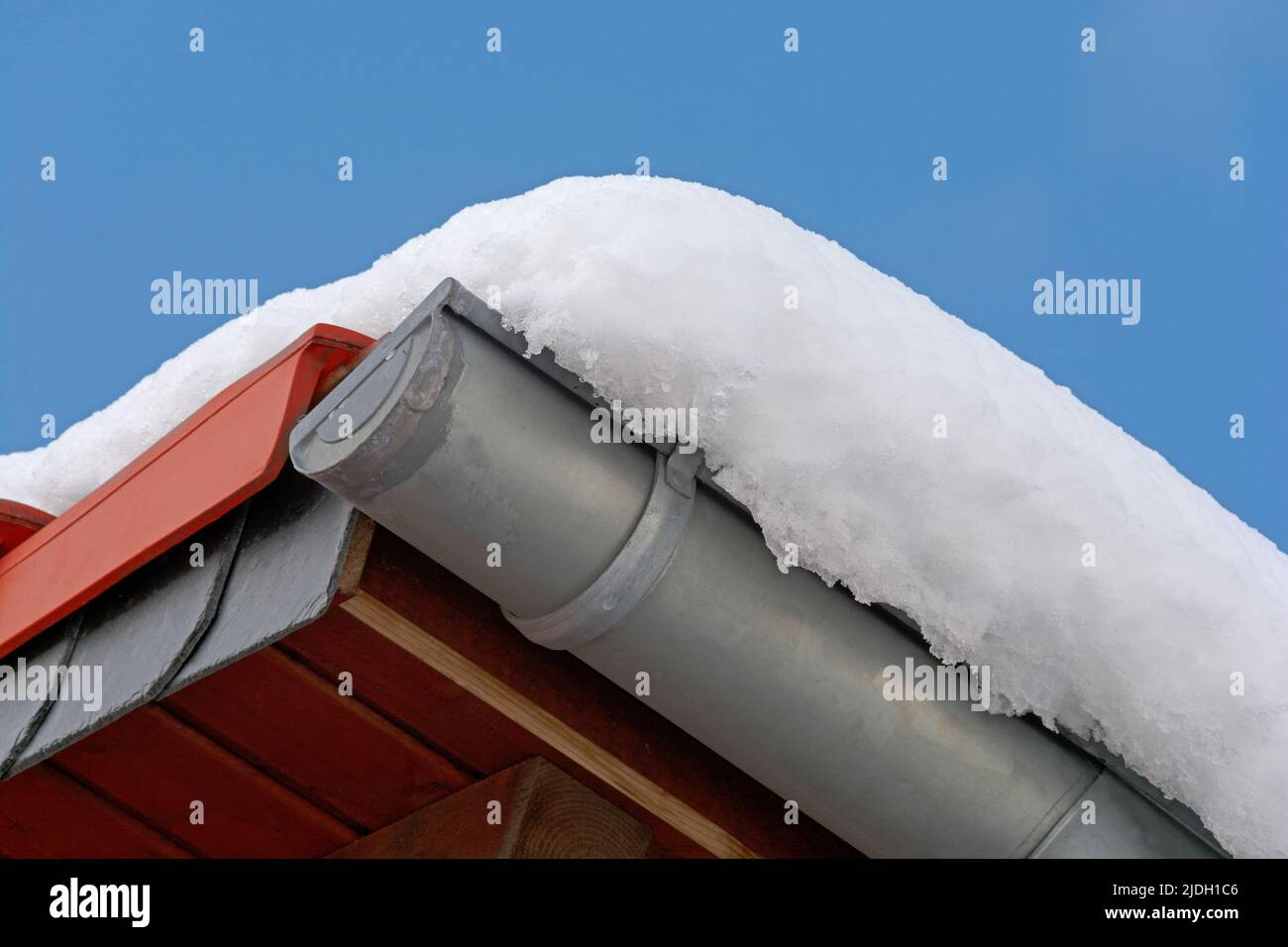 Roof with snow on a sunny day with blue sky as background Stock Photo ...