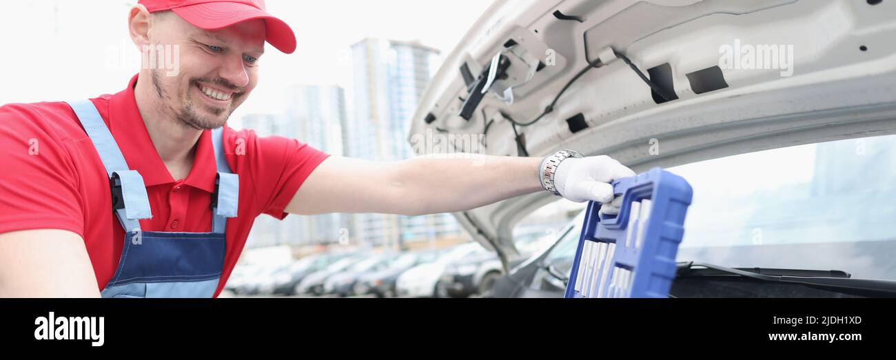 Automotive technician smiling and open kit full of equipments Stock ...