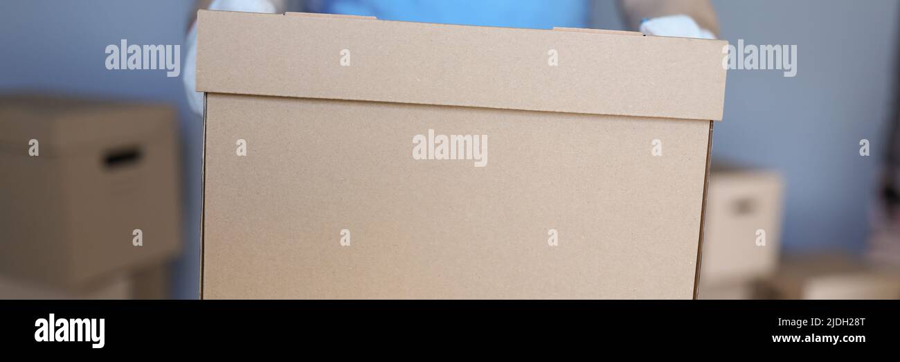 Worker loading cardboard boxes with owners belongings to new apartment ...
