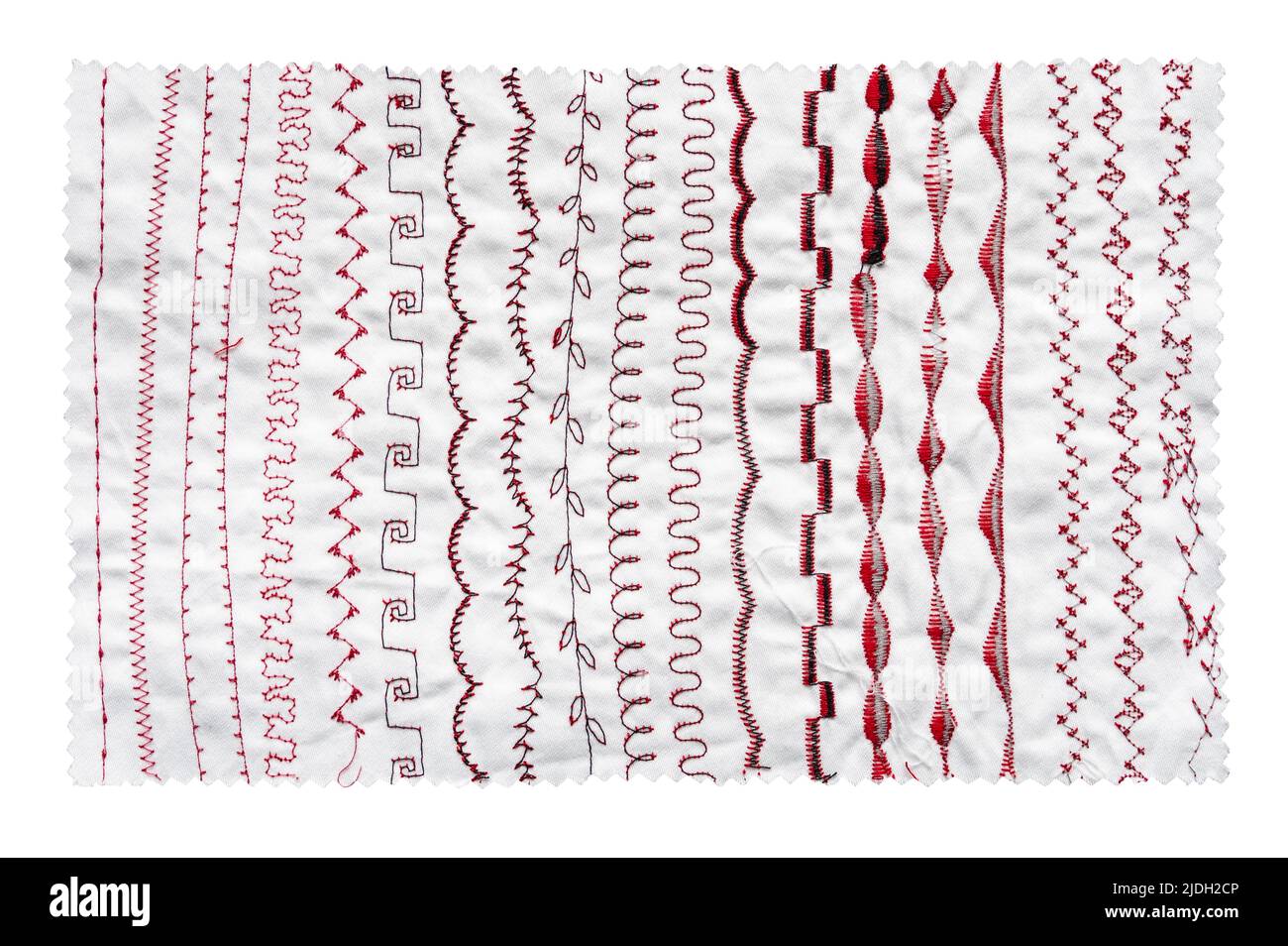 back side of cloth with samples of stitches of sewing machine cut out ...