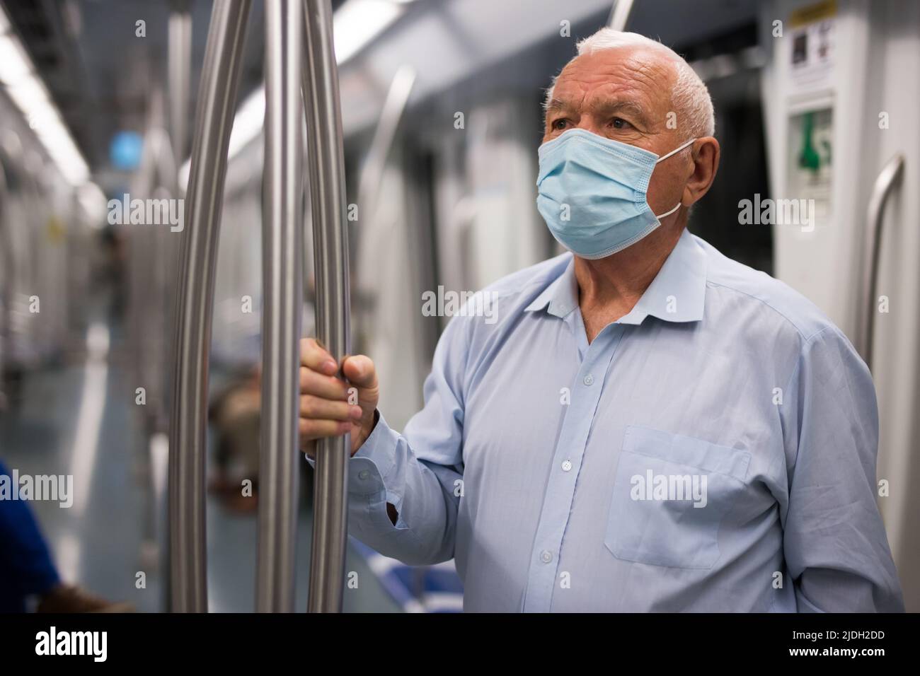 Senior man in mask inside subway car Stock Photo - Alamy