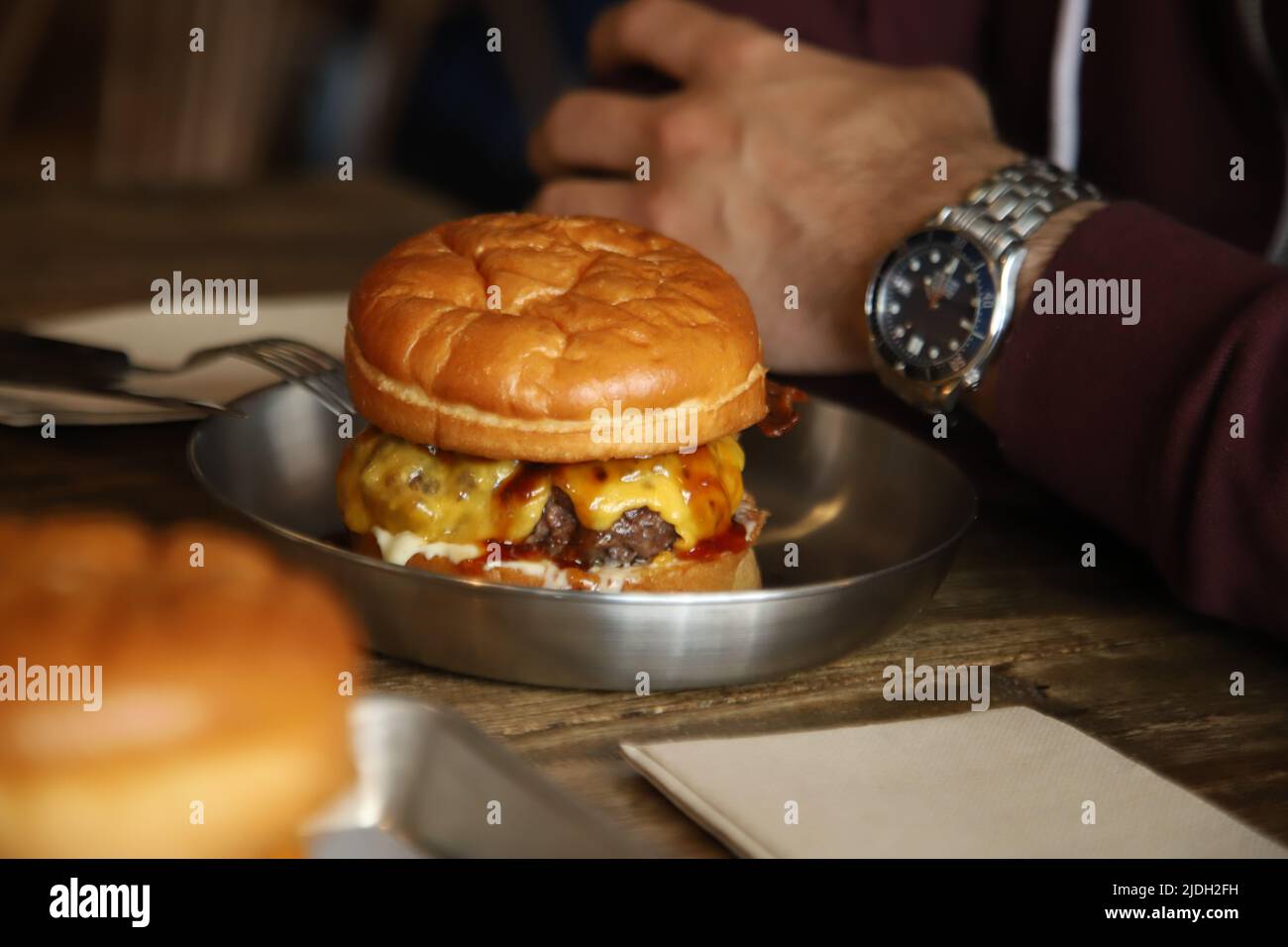 Hamburger with dripping cheese and sauce Stock Photo - Alamy