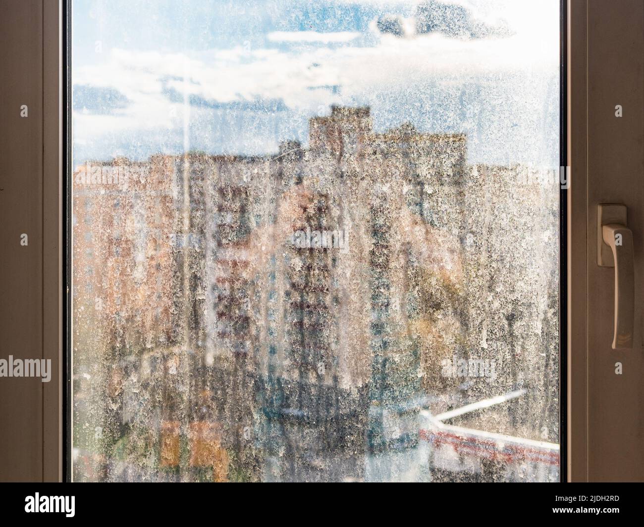 dirty window glass in apartment building and outdoors view through in ...