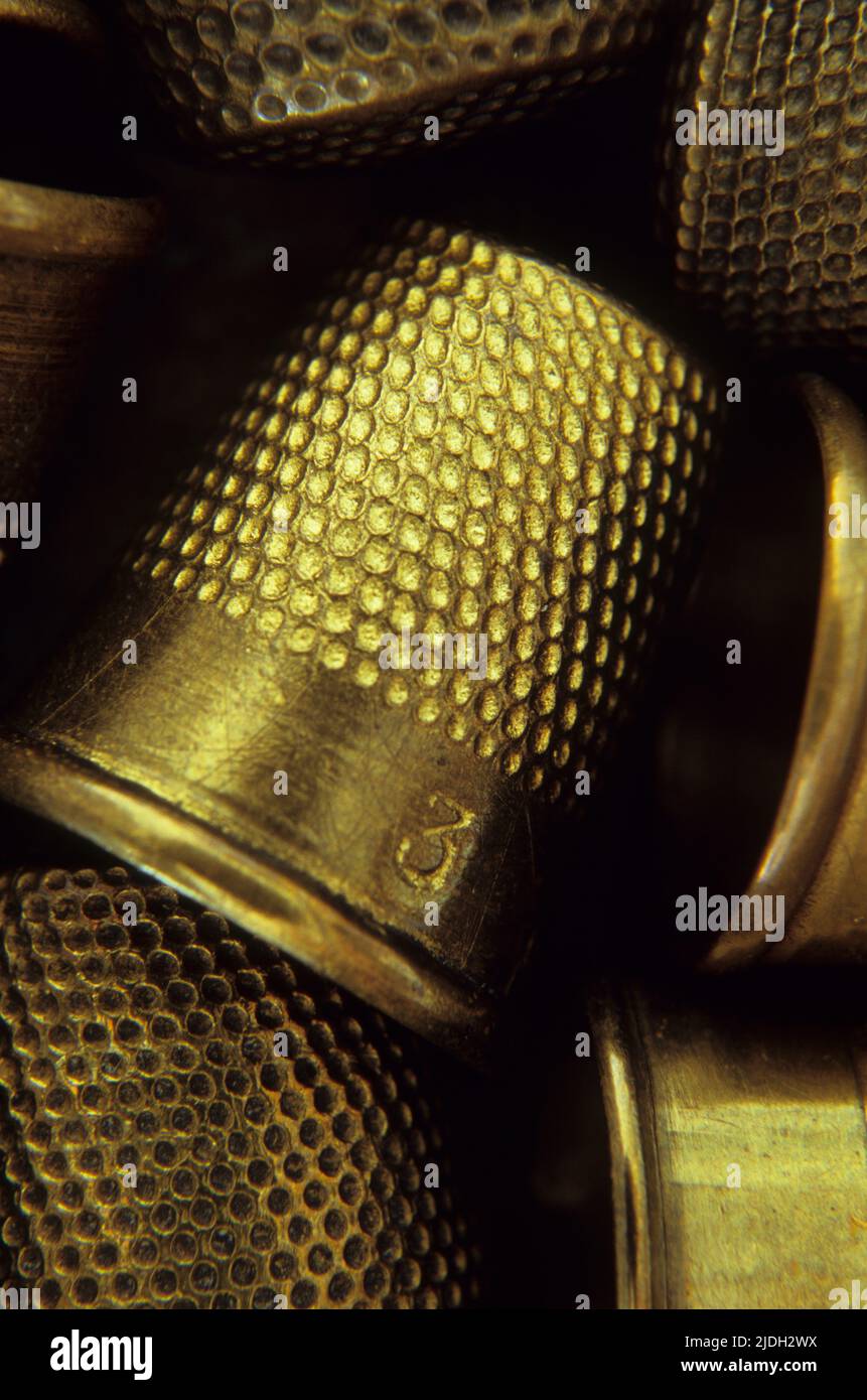 Collection of antique brass thimbles with close view of one with its ...