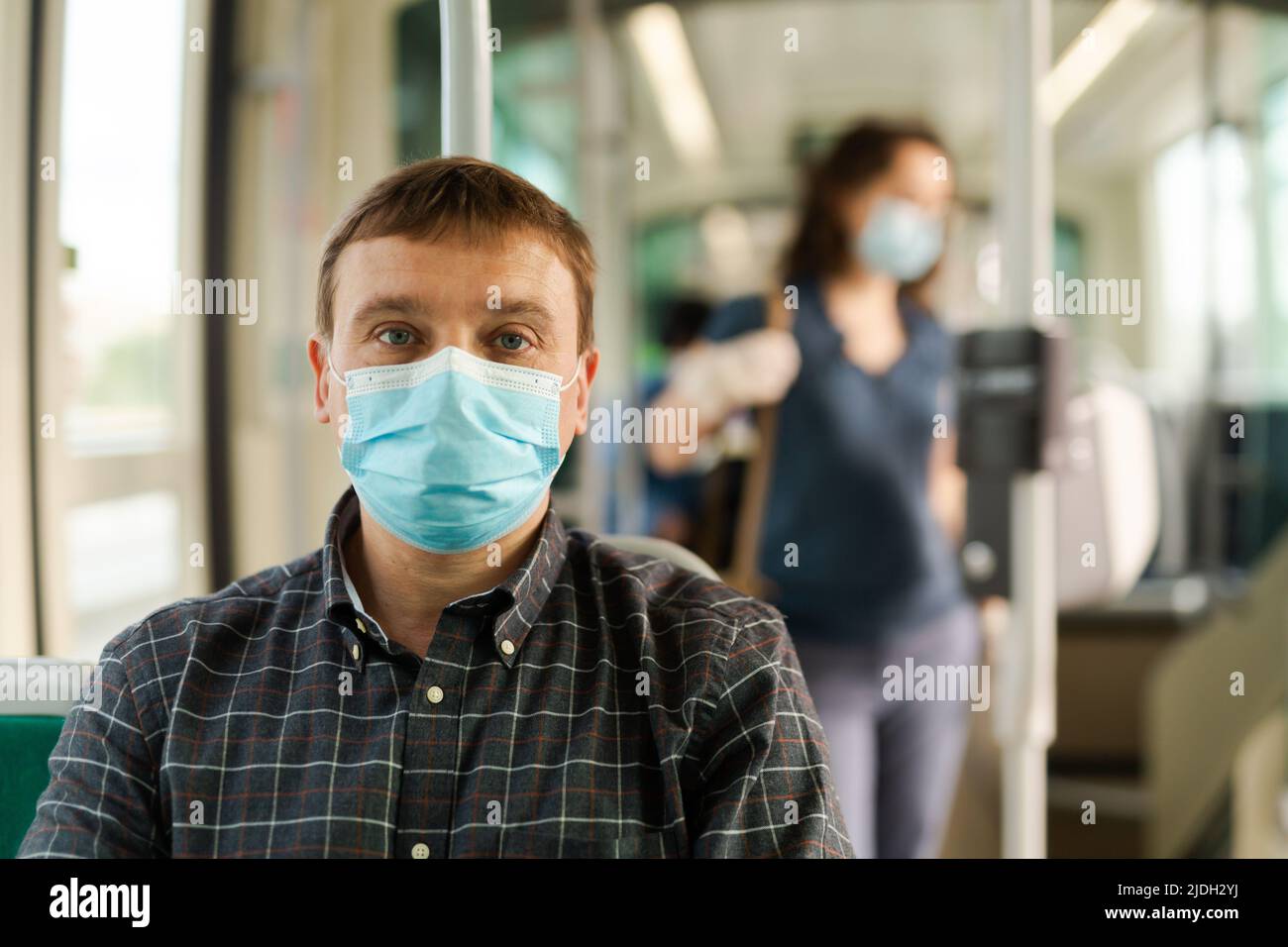 Man in protective medical mask rides in public transport Stock Photo ...