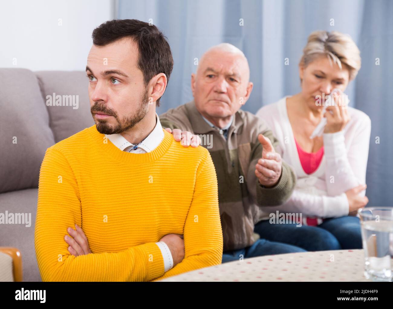 Parents arguing with son Stock Photo - Alamy
