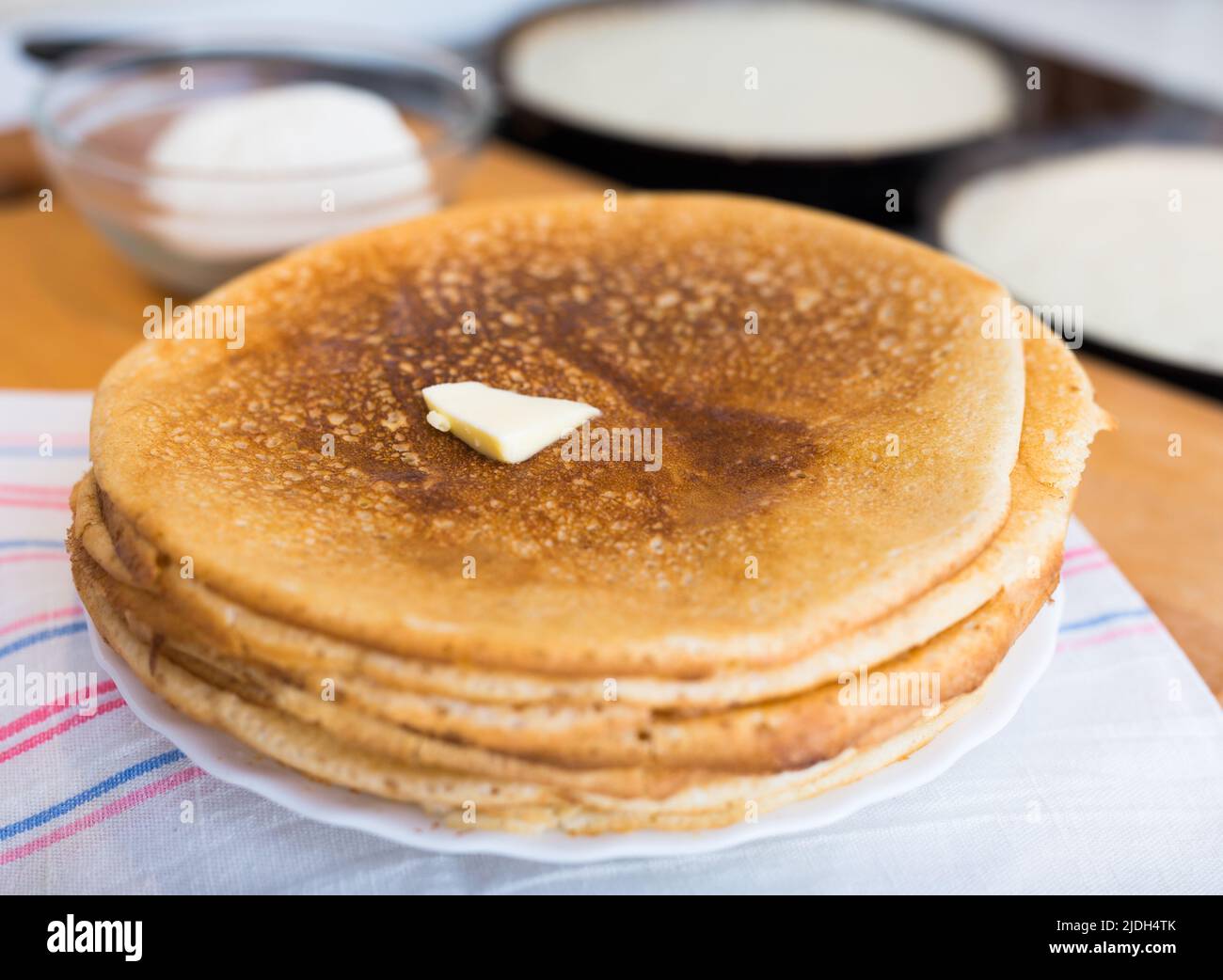 hot golden pancakes made from grain flour in kitchen while cooking on ...
