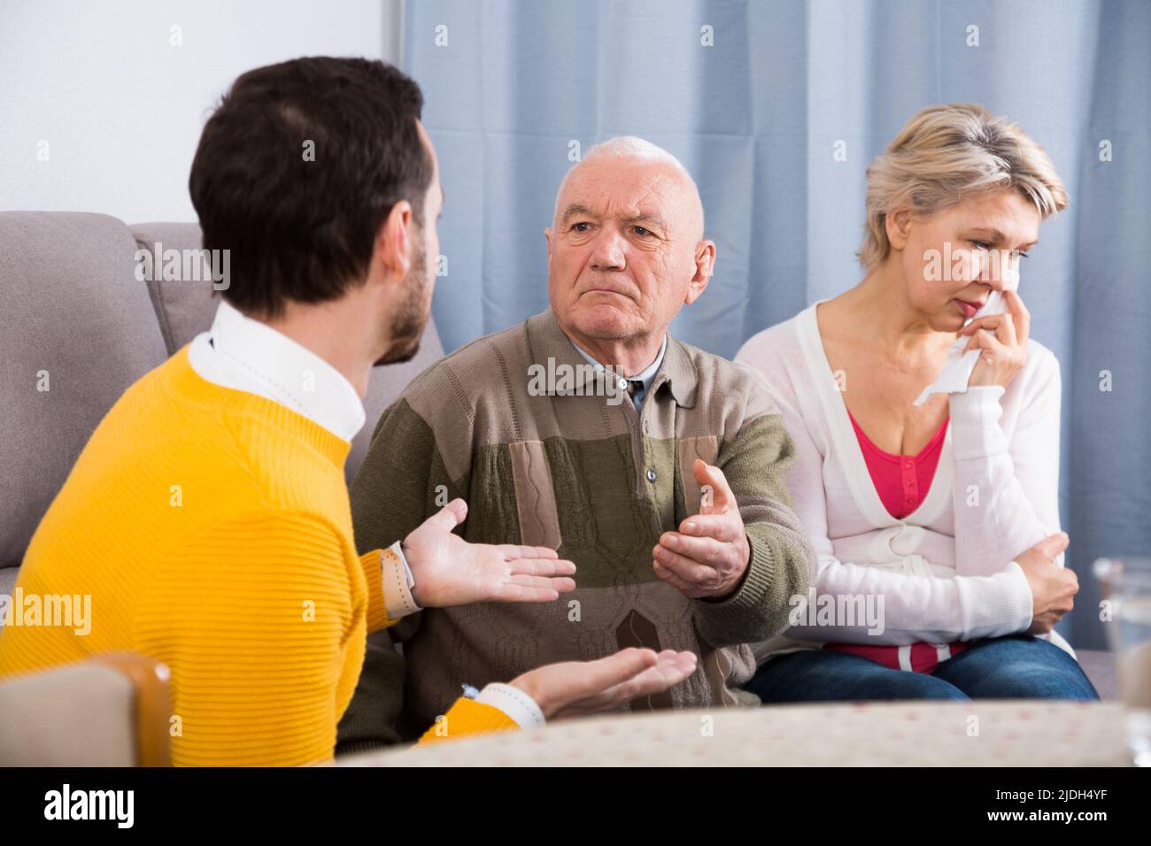 Parents arguing with son Stock Photo - Alamy
