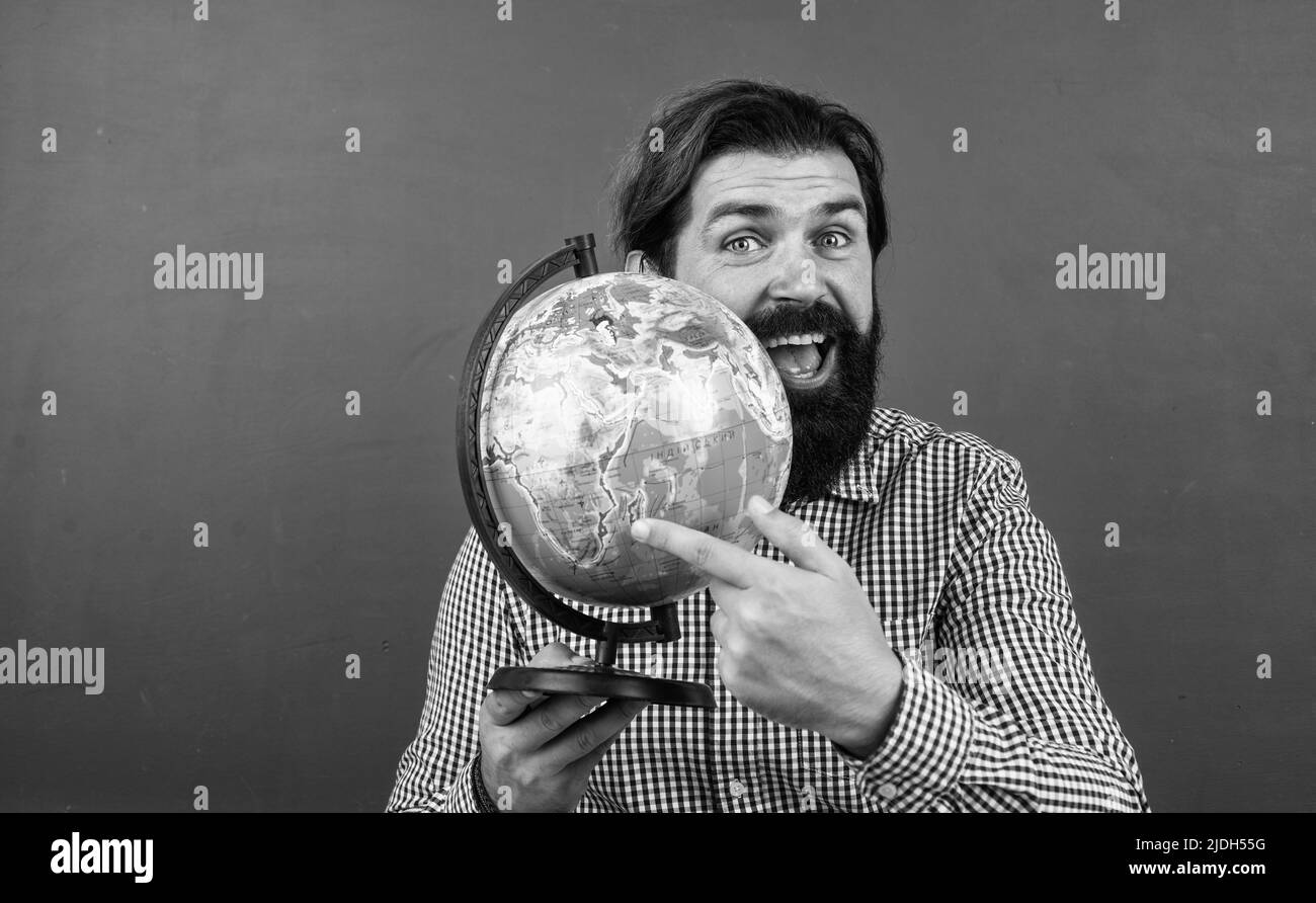cheerful bearded man in checkered shirt holding geographic globe ...