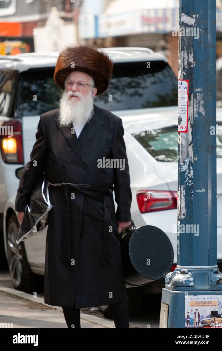 An orthodox Jewish man, likely a rabbi, wears his striemel fur hat to a ...