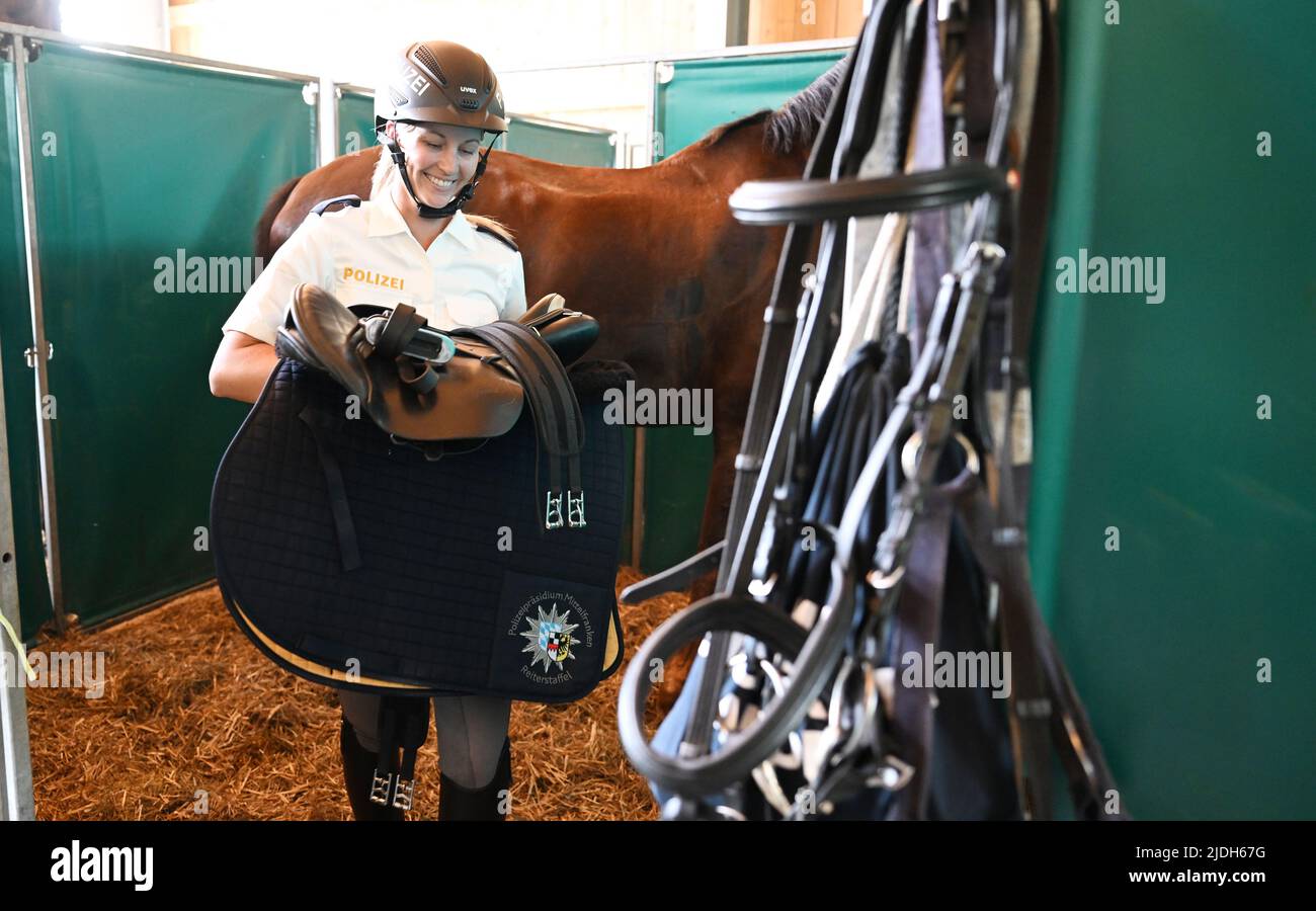 Wallgau, Germany. 21st June, 2022. A police rider looks after her horse ...