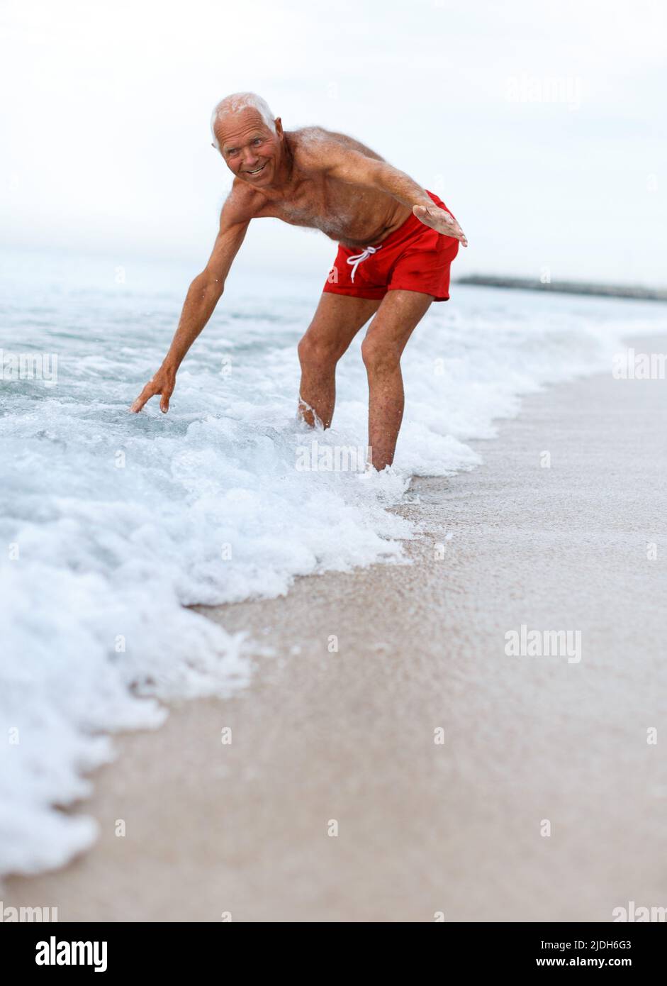 Portrait of great man checks water temperature Stock Photo - Alamy