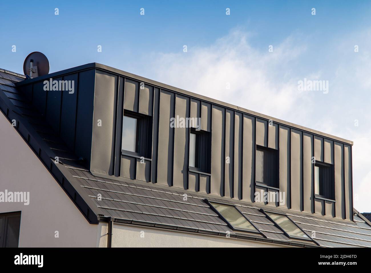 Newly tiled roof with large dormer with standing seam cladding Stock ...