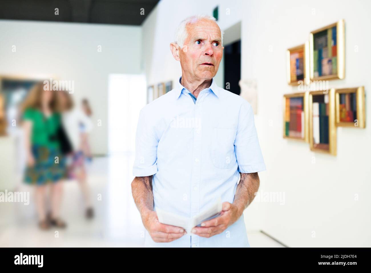 Man observing painting gallery Stock Photo - Alamy