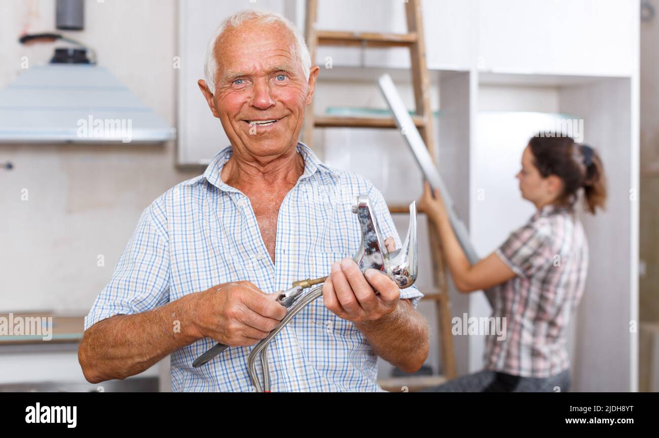 Senior man with mixer tap Stock Photo - Alamy