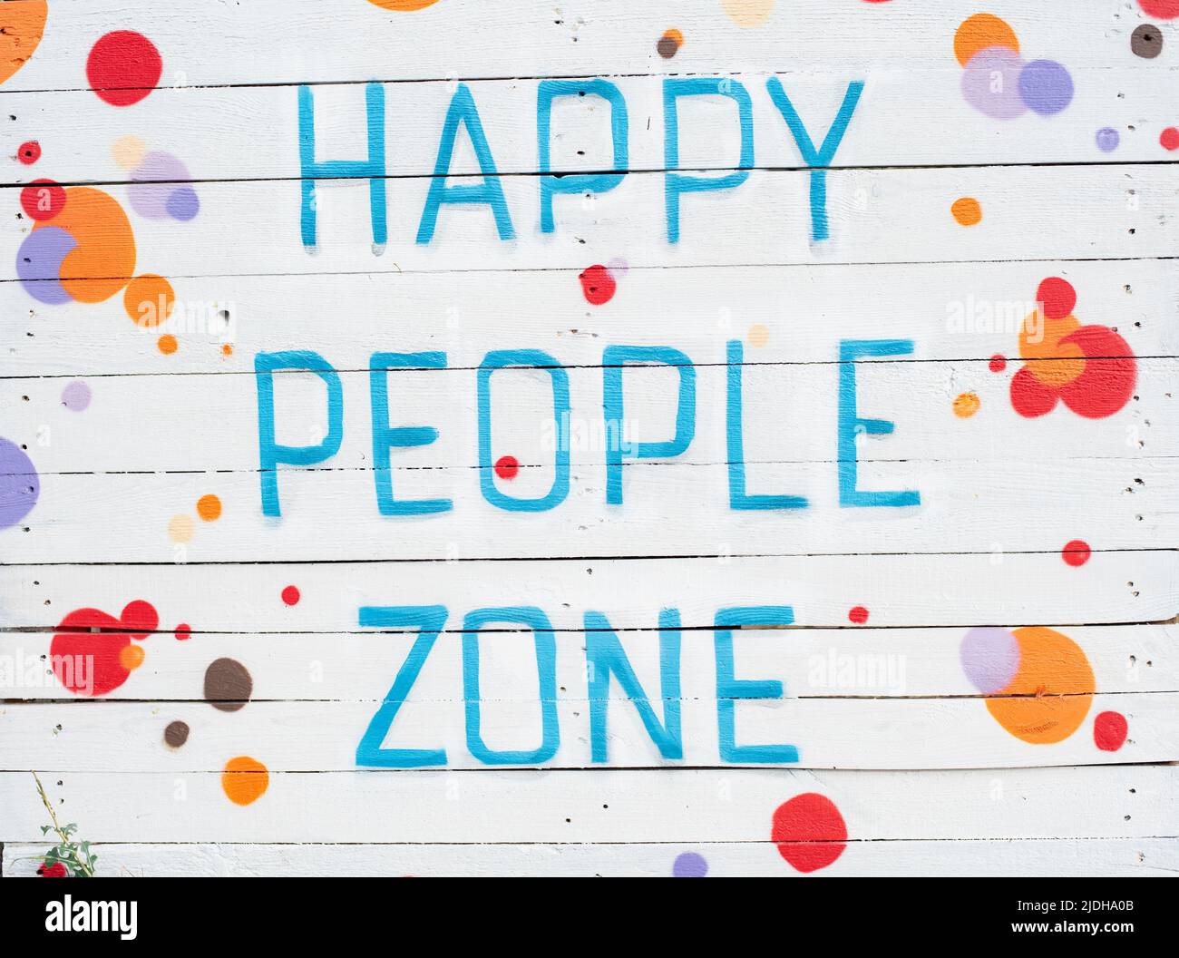 Text in English Happy people zone on white wooden plank background ...