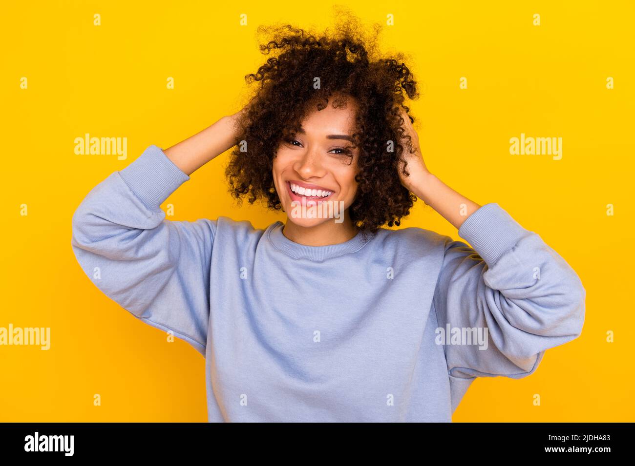 Photo of funky positive person hands touch head hair toothy smile good ...