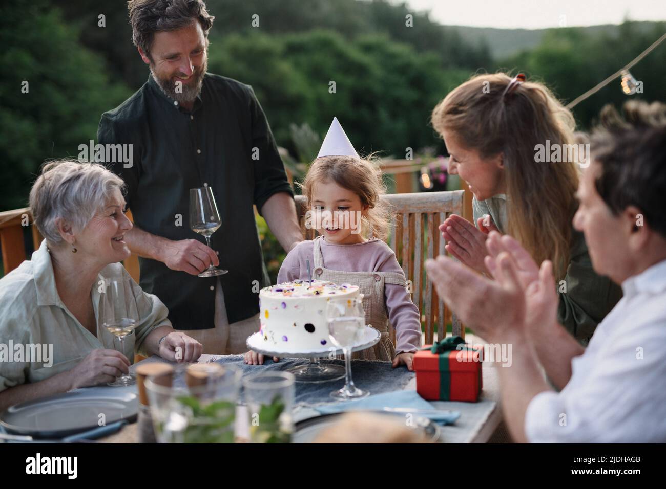 Multi generation family celebrating birthday of little girl and having ...